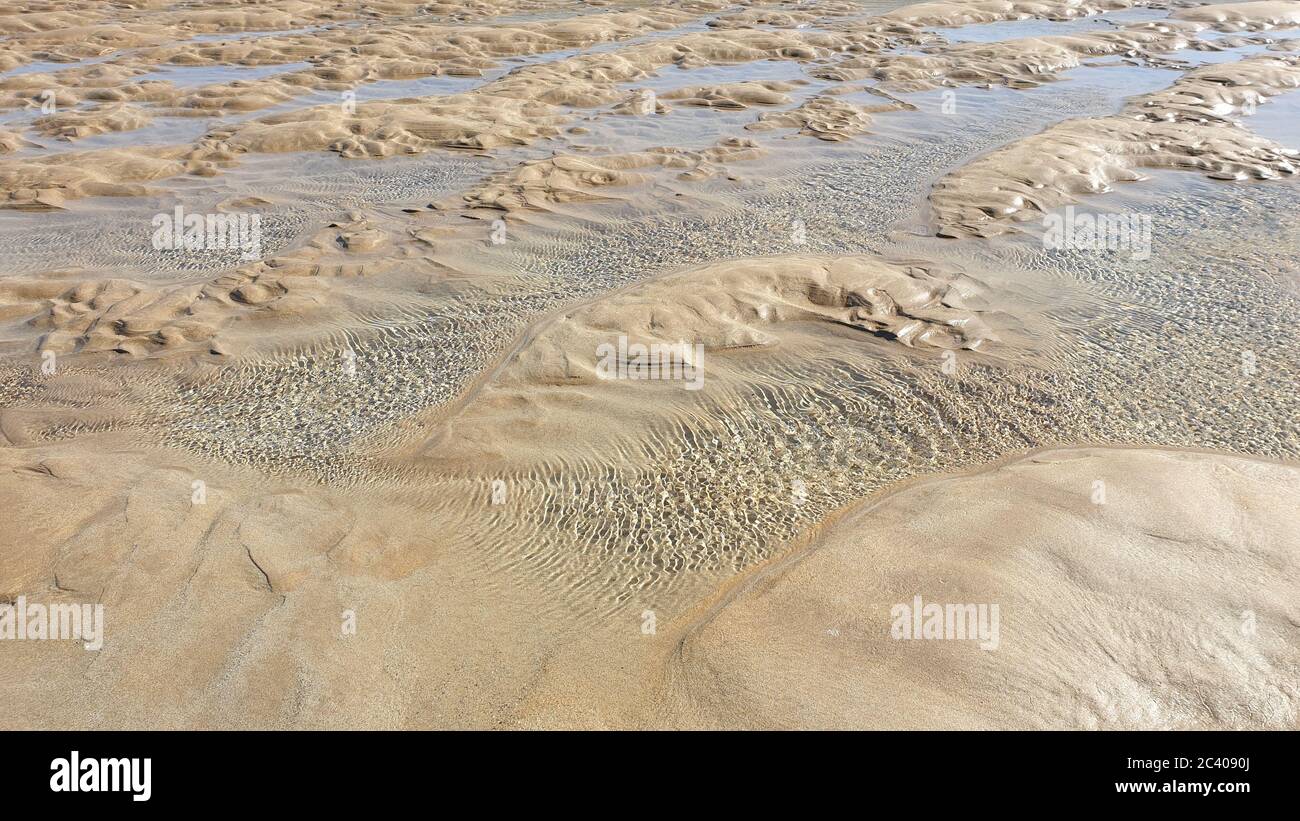 Sand and water Stock Photo - Alamy