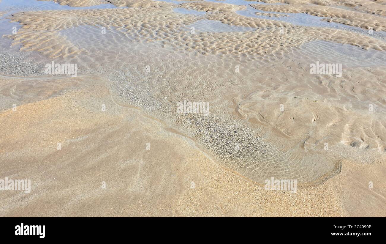 Sand and water Stock Photo - Alamy