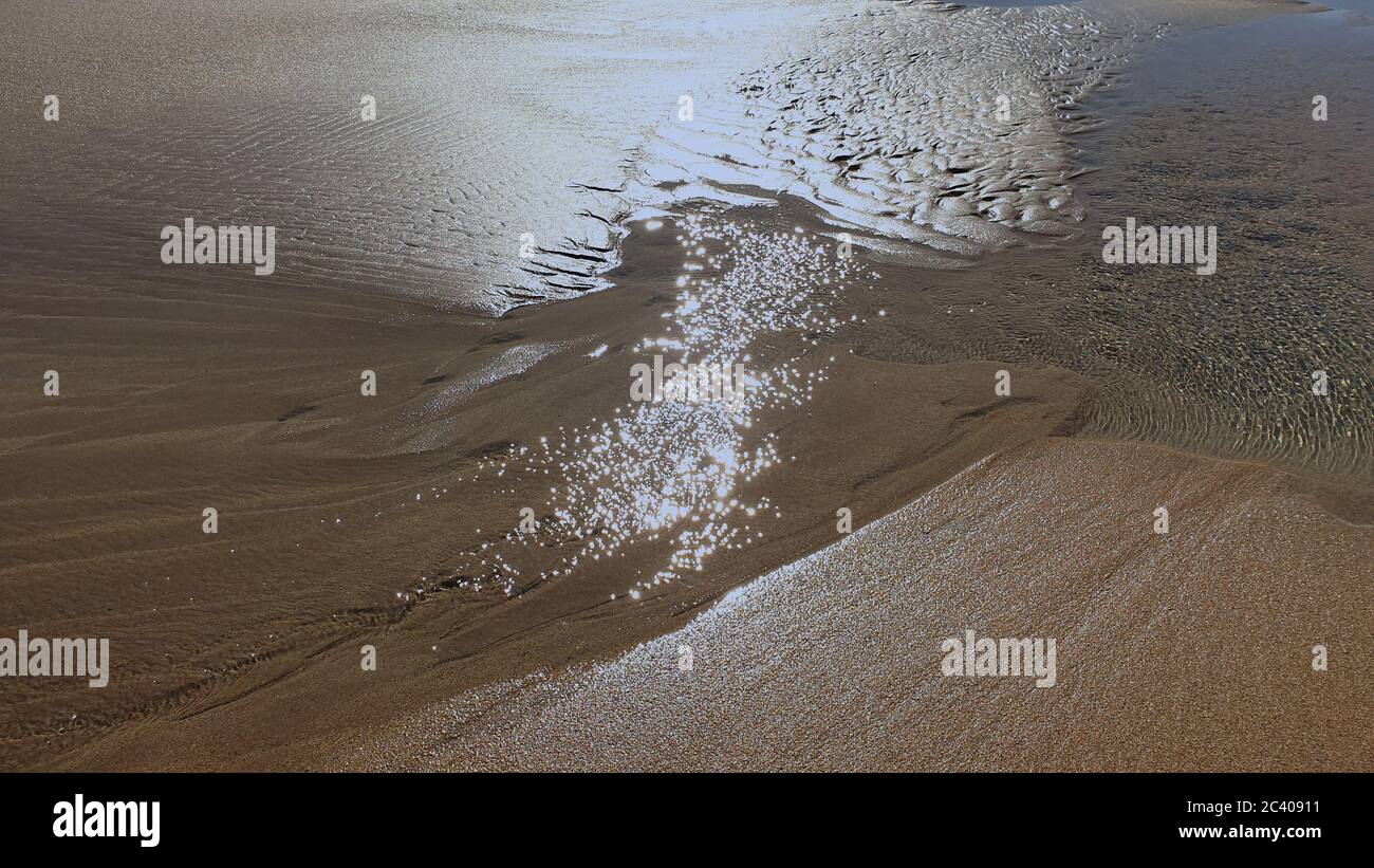 Sand and water Stock Photo - Alamy