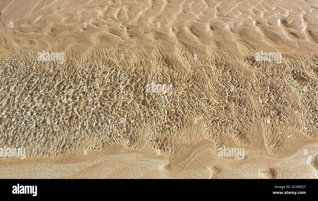 Sand and water Stock Photo - Alamy