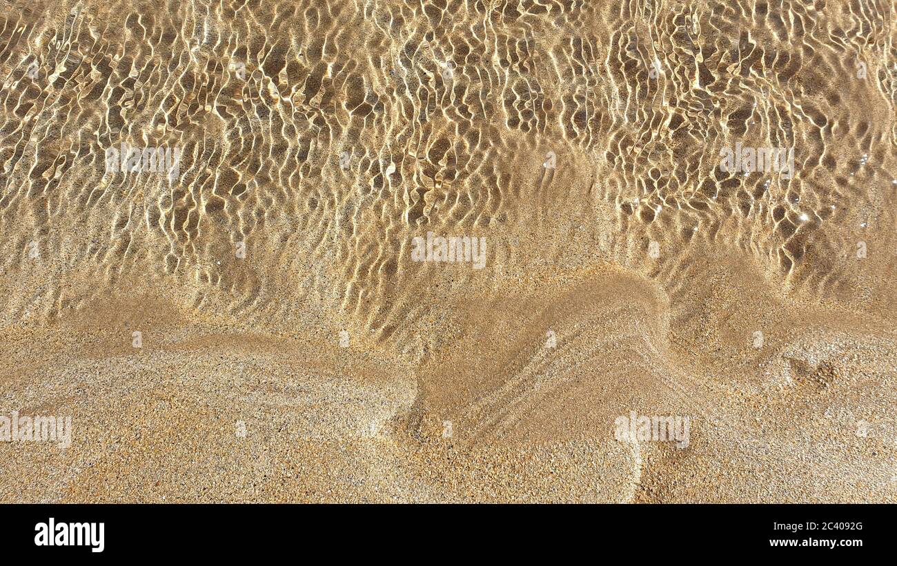 Sand and water Stock Photo - Alamy