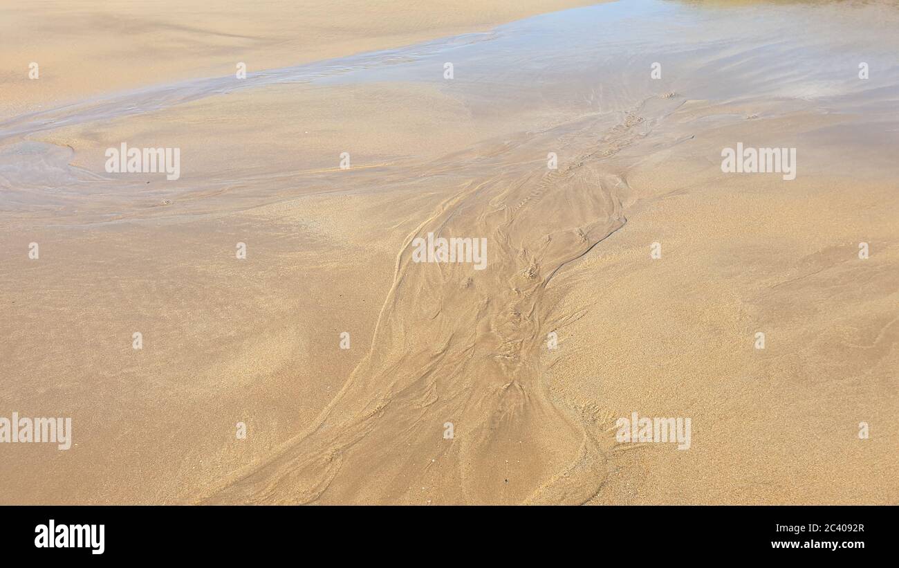 Sand and water Stock Photo - Alamy