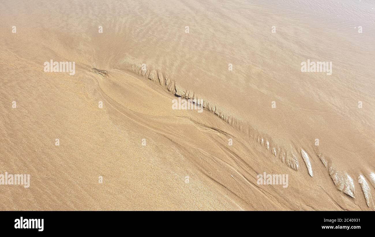 Sand and water Stock Photo - Alamy