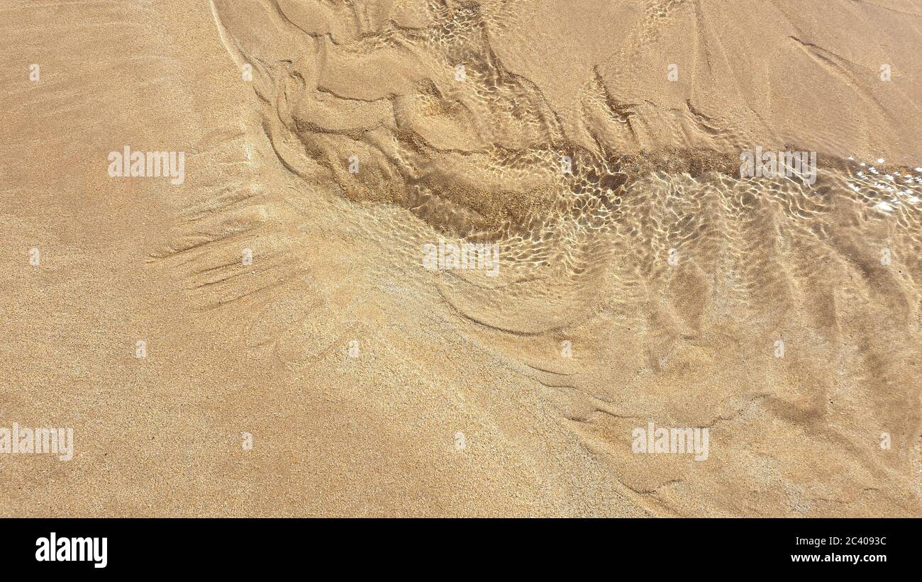 Sand and water Stock Photo - Alamy