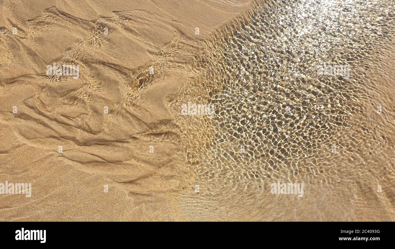 Sand and water Stock Photo - Alamy