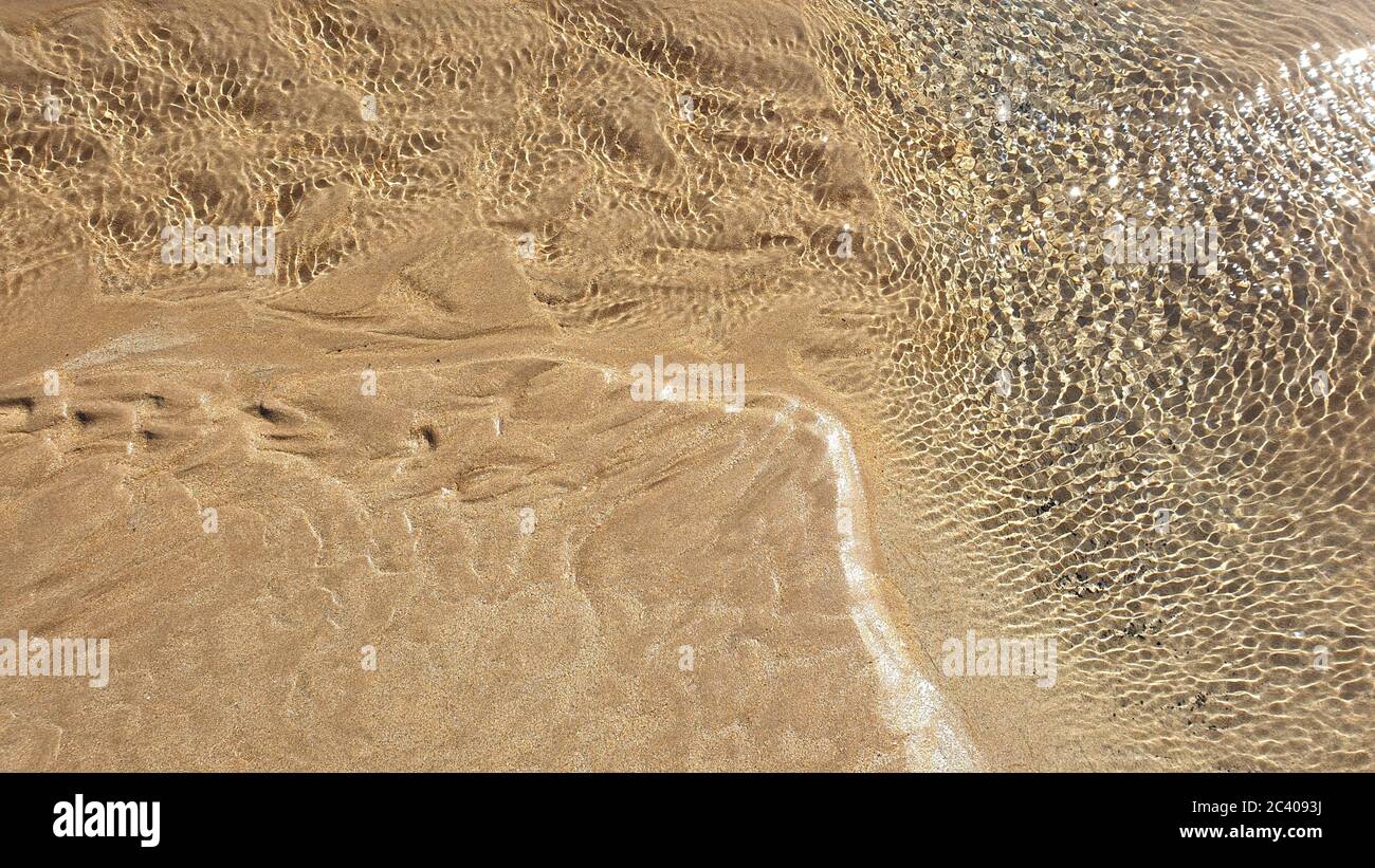 Sand and water Stock Photo - Alamy