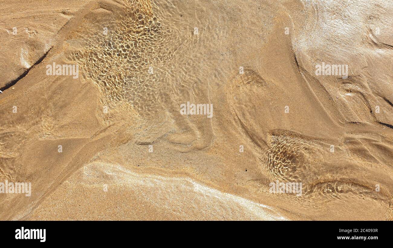 Sand and water Stock Photo - Alamy