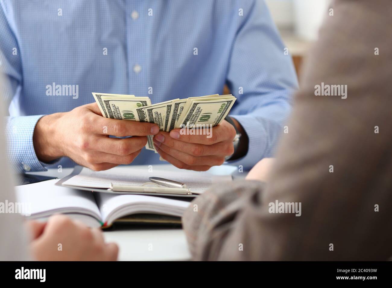 Young man counting dollar in hi-res stock photography and images - Alamy