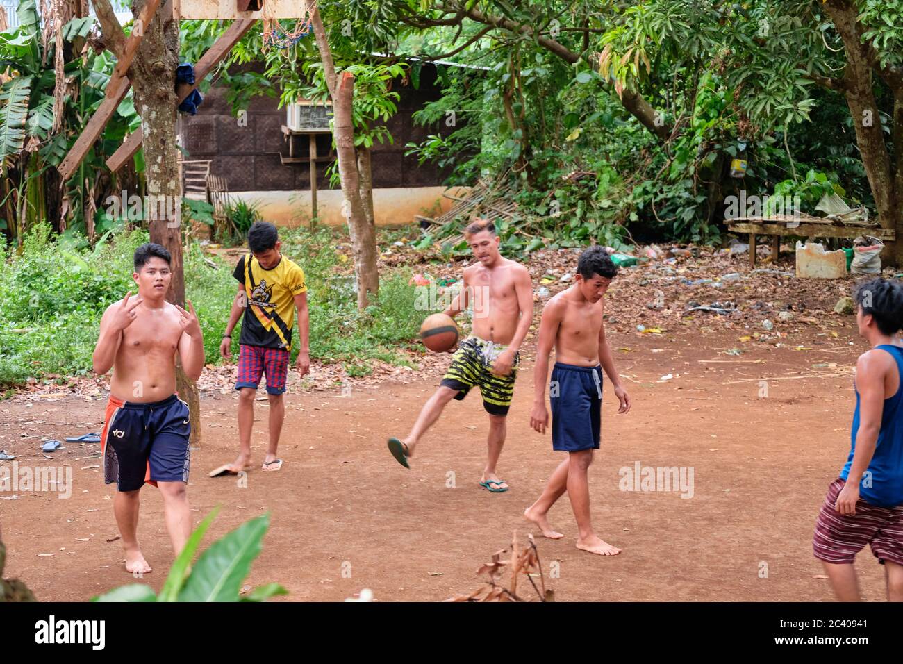 Local residents play basketball on an unequipped Playground Stock Photo ...