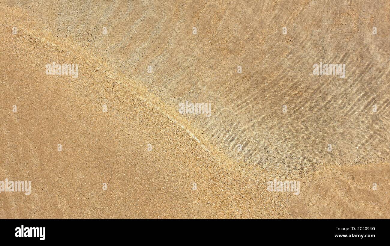 Sand and water Stock Photo - Alamy