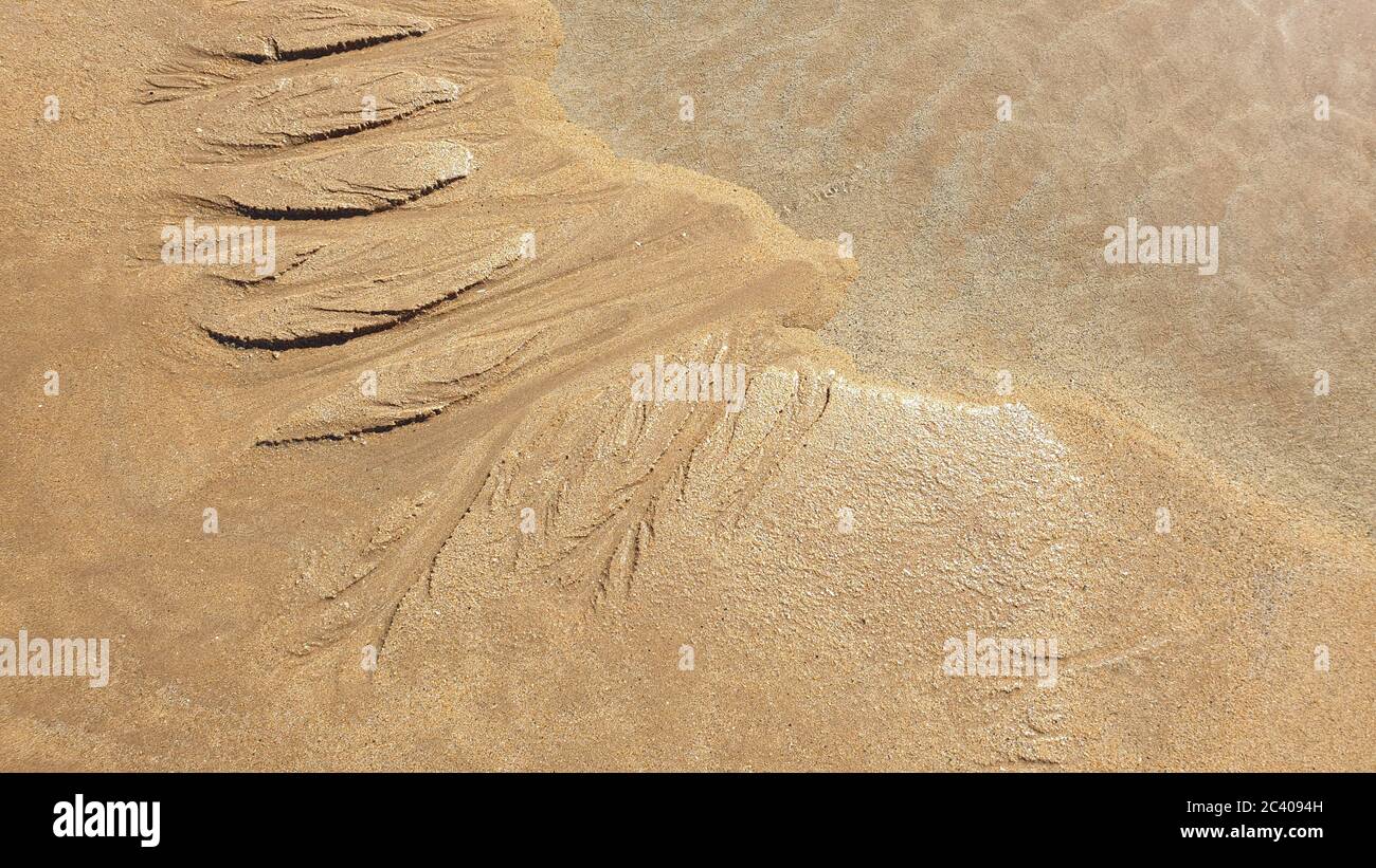 Sand and water Stock Photo - Alamy