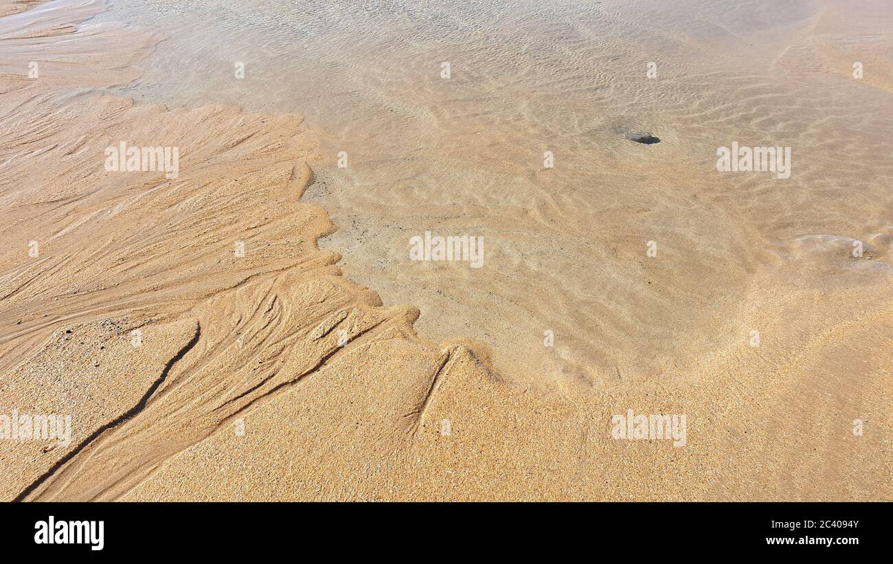 Sand and water Stock Photo - Alamy