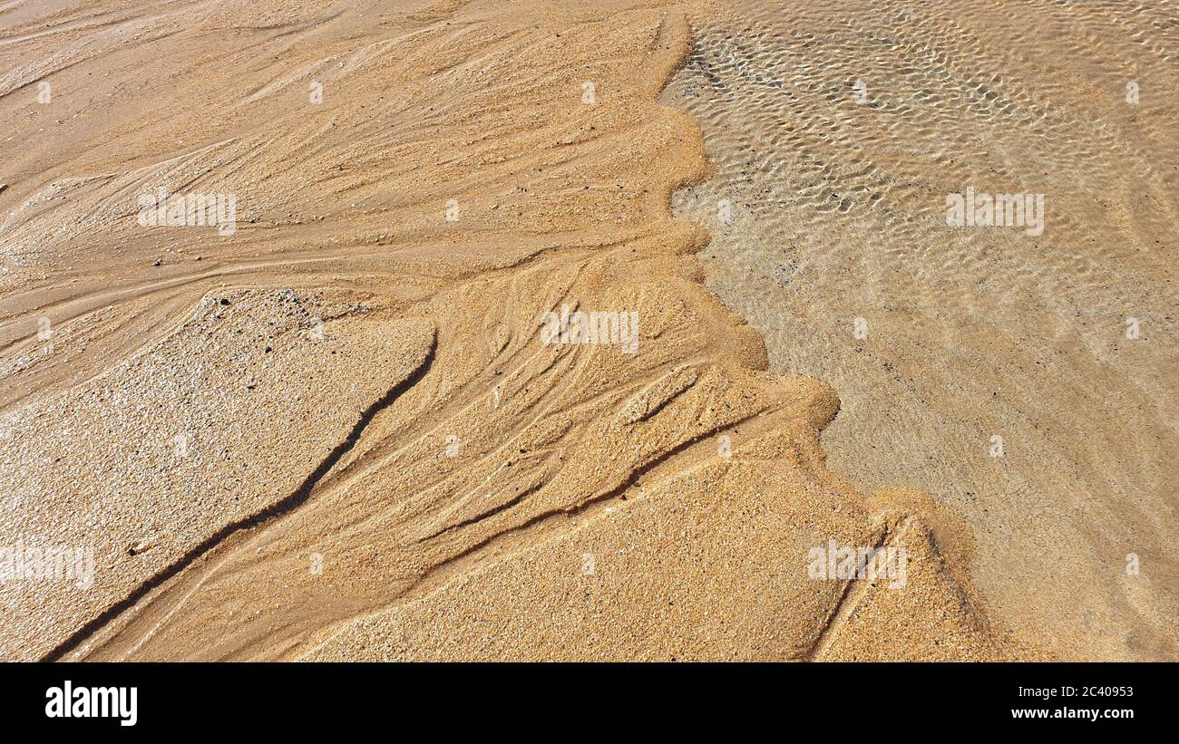Sand and water Stock Photo - Alamy