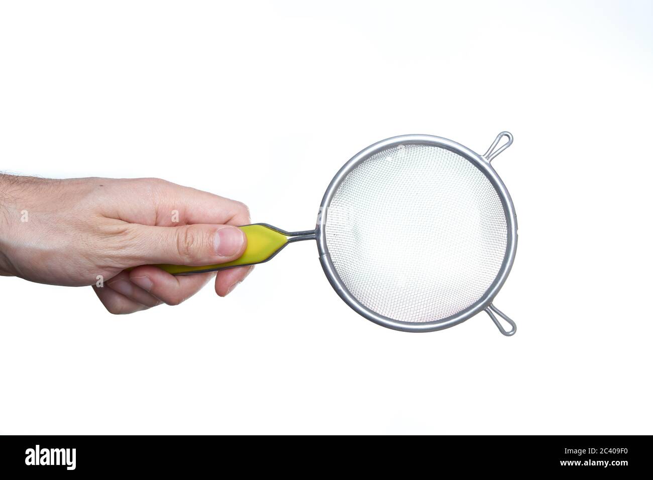 man hand holding strainer utensil. Kitchen concept Stock Photo - Alamy
