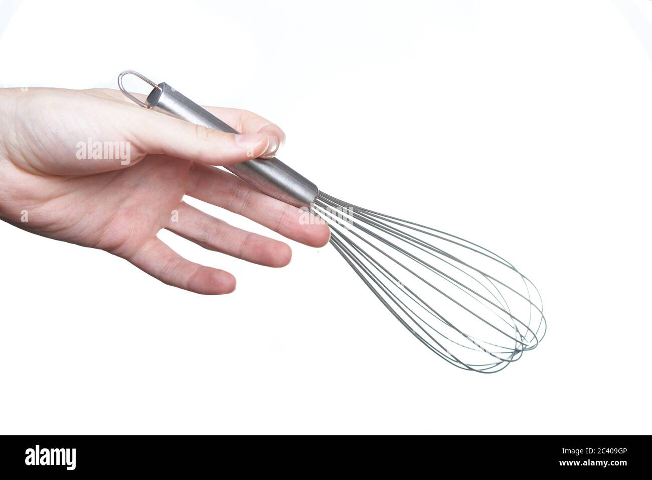 hand holds a kitchen whisk, isolated on white Stock Photo - Alamy