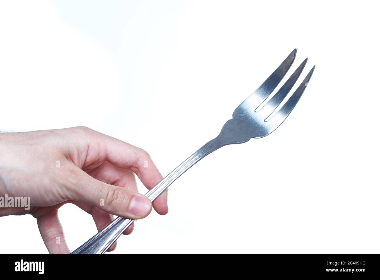 mand holding a giant fork. Devil in the kitchen concept Stock Photo - Alamy