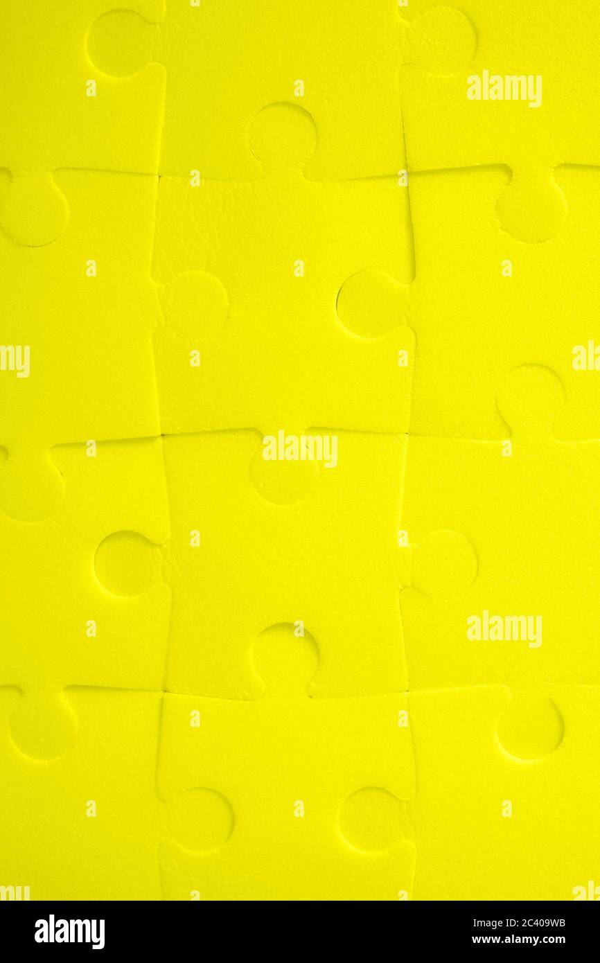 Multiple yellow puzzle pieces put together. View from above, vertical ...
