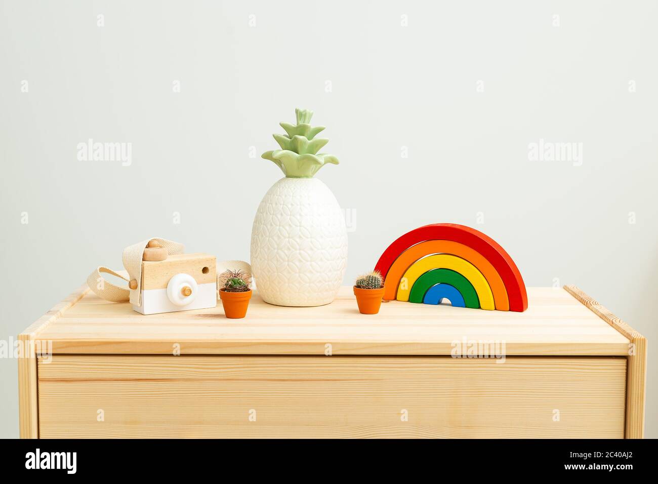 Children's wooden toys rainbow and Houseplant on wooden shelf. Zero ...
