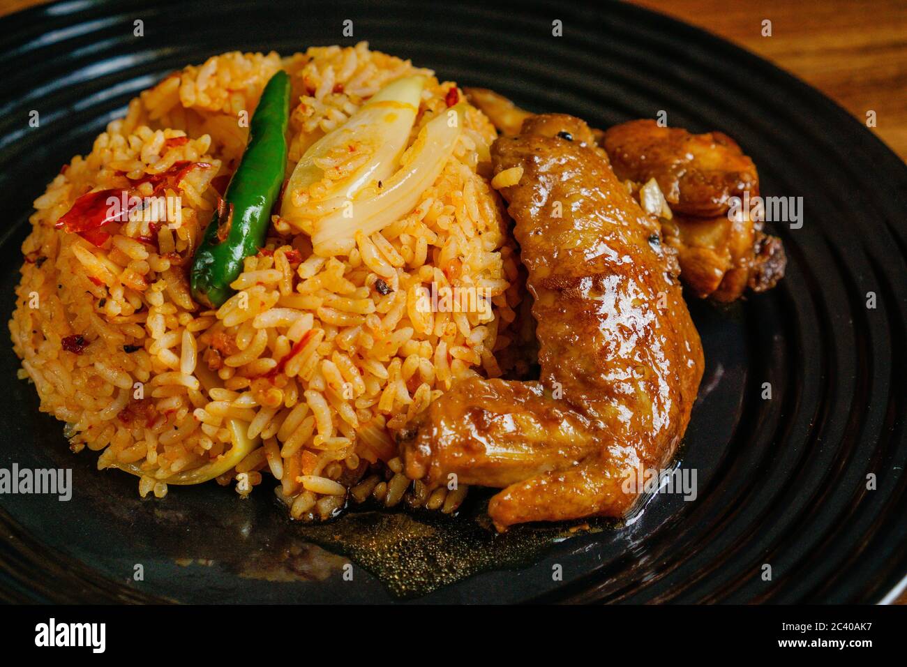 Spicy fried rice with grilled black pepper chicken wings Stock Photo ...