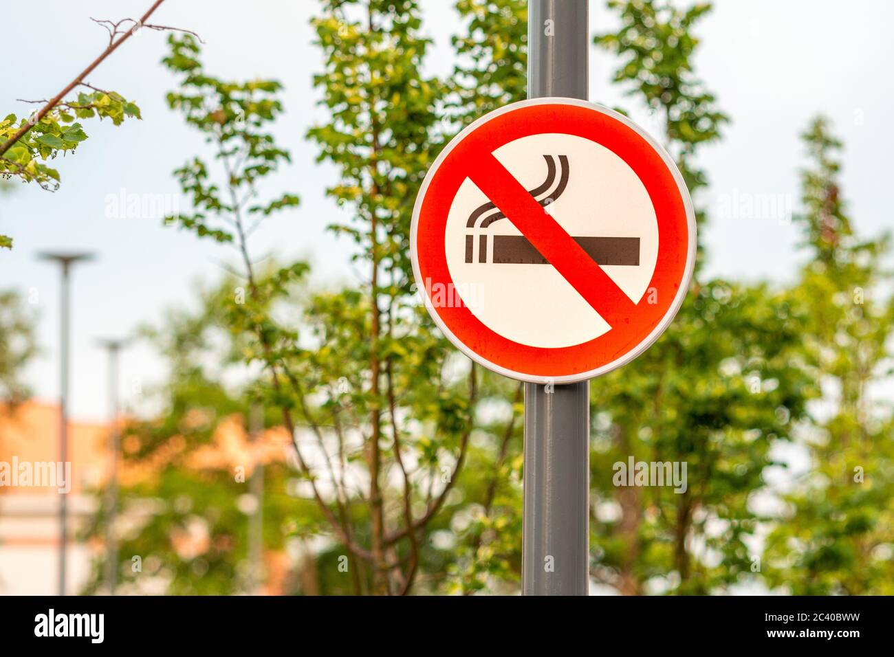 No Smoking Label Stick to the pole in the public park with blur ...