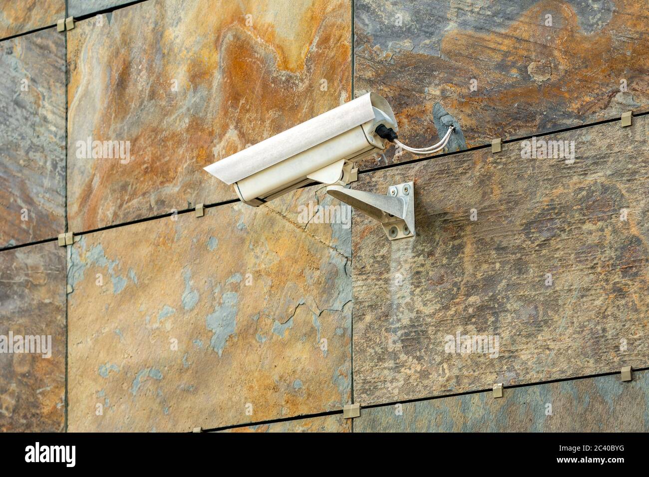 Surveillance camera mounted on the wall of the building Stock Photo - Alamy