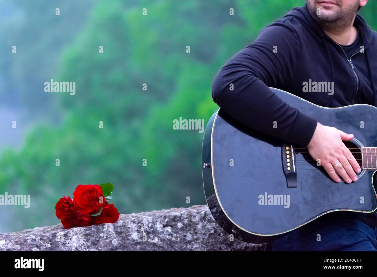 Romantic scene of man playing guitar leaning against the bridge Stock ...