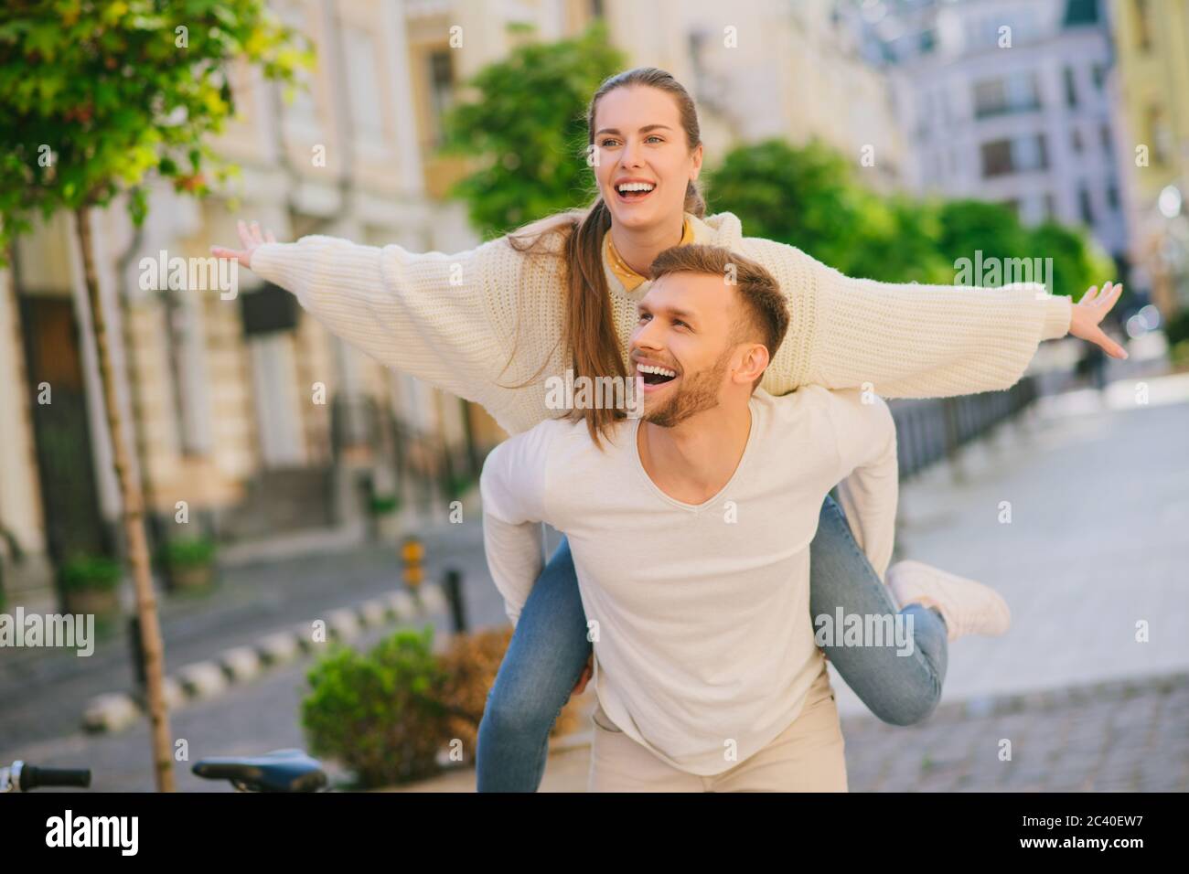 Young woman riding on the back of a man Stock Photo - Alamy