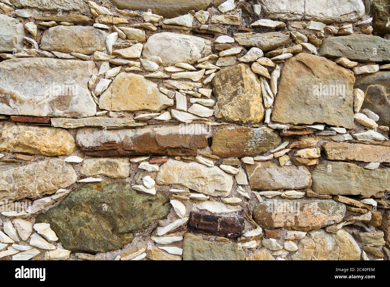 Multi-colored stones on the ground. Different shapes and sizes. Texture ...