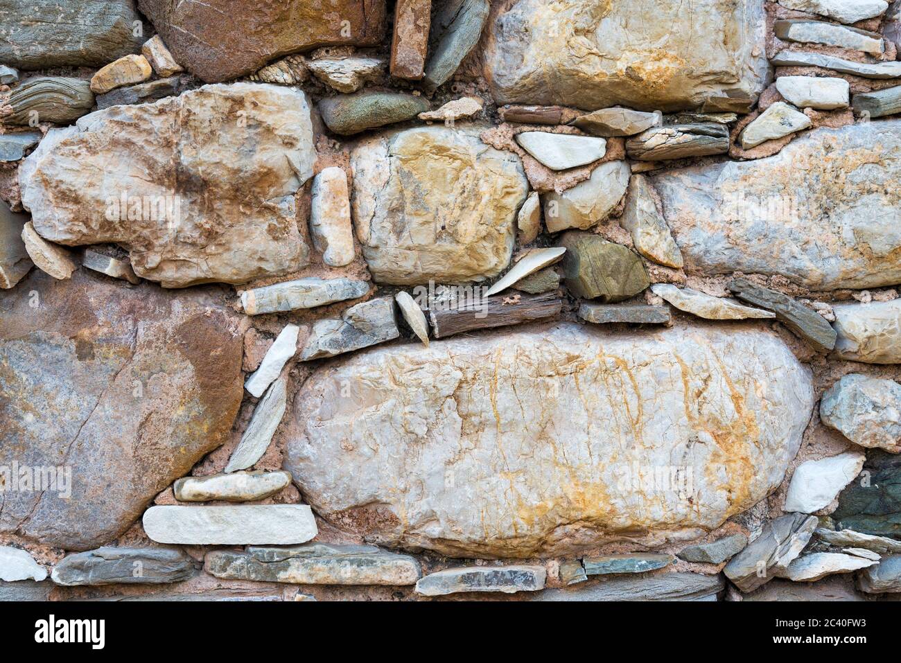 Multi-colored stones on the ground. Different shapes and sizes. Texture ...