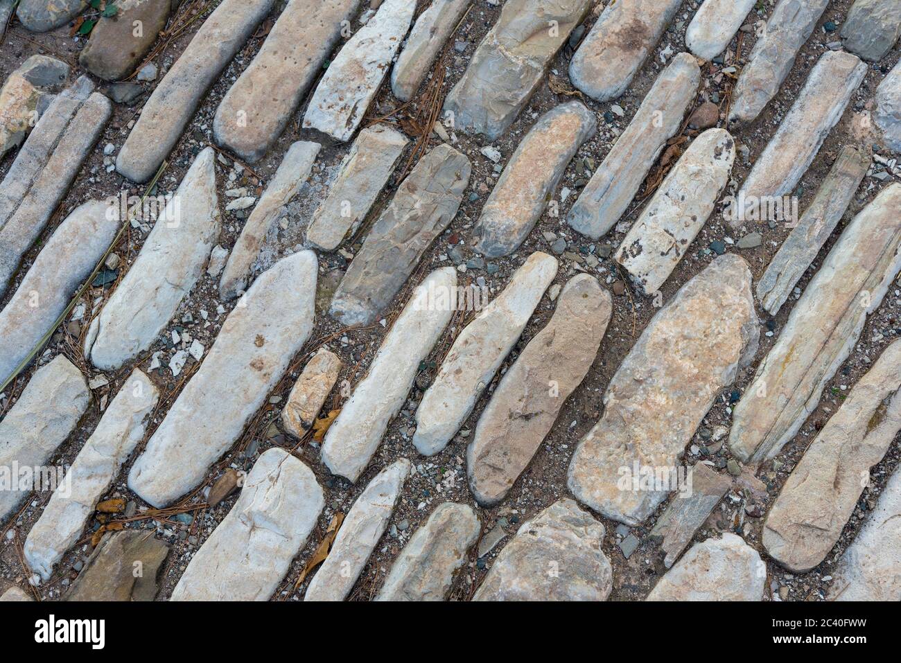 Multi-colored stones on the ground. Different shapes and sizes. Texture ...