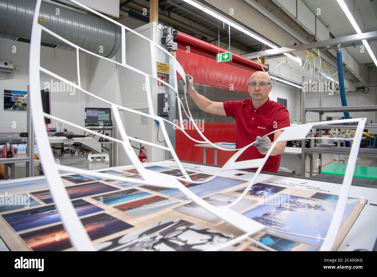 Oldenburg, Germany. 20th May, 2020. An employee of the photo service ...