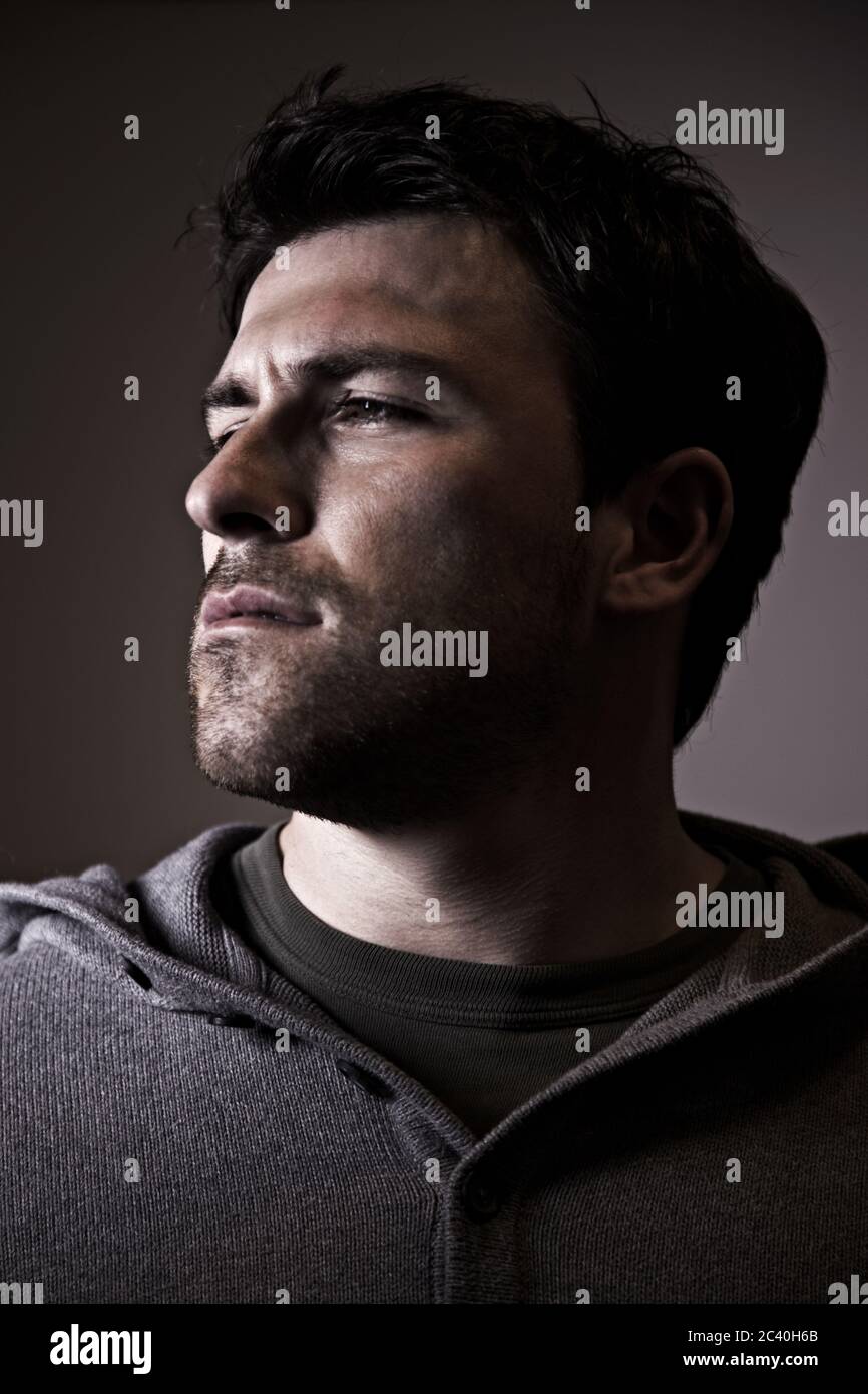 Dark portrait of a young man Stock Photo - Alamy