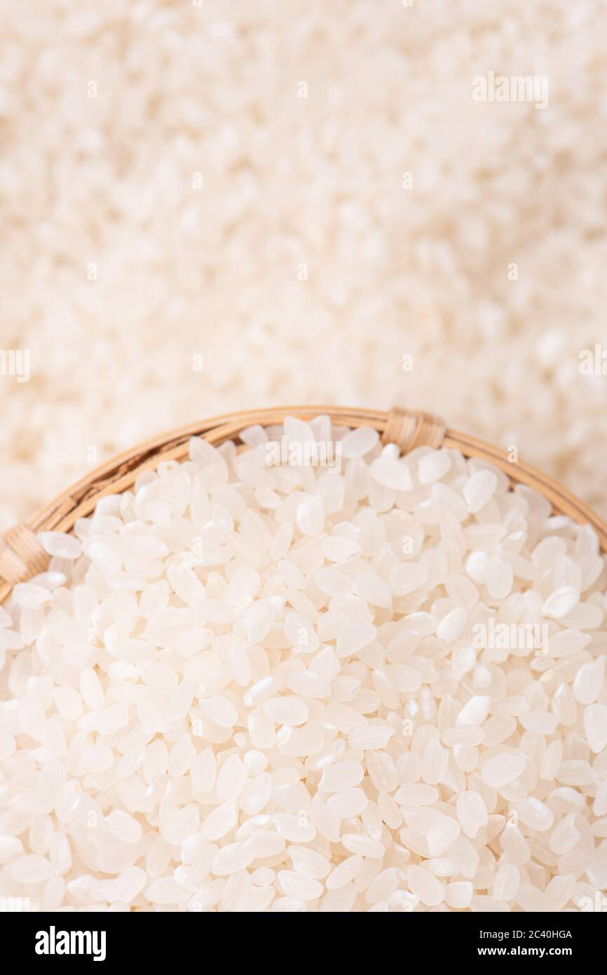 Raw rice in a bowl and full frame in the white background table, top ...