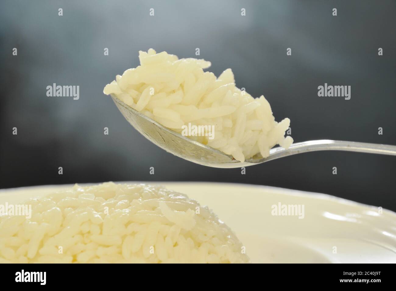 plain rice scooping on silver spoon with smoke floating Stock Photo - Alamy