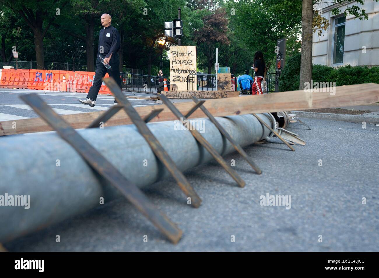 A homemade barricade lines the street near Lafayette Square across from ...