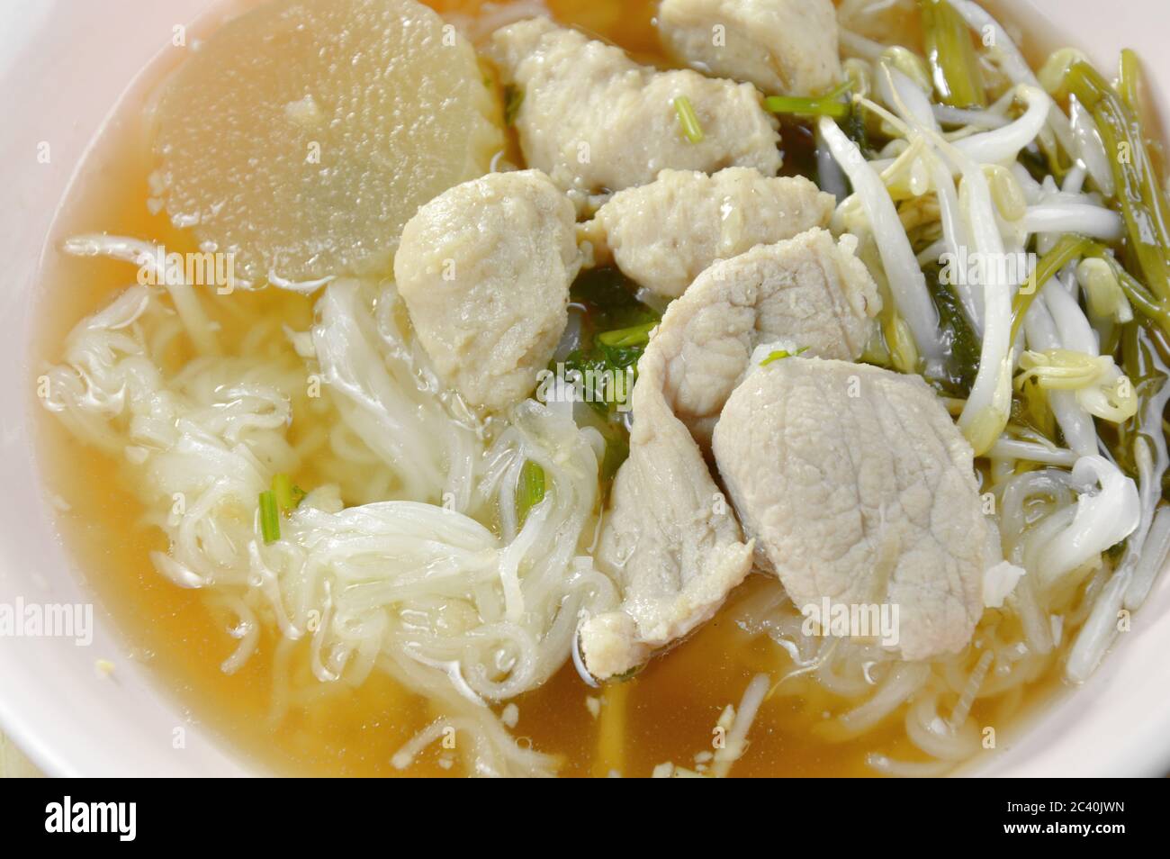 boiled rice noodles topping slice pork and ball in clear soup Stock ...