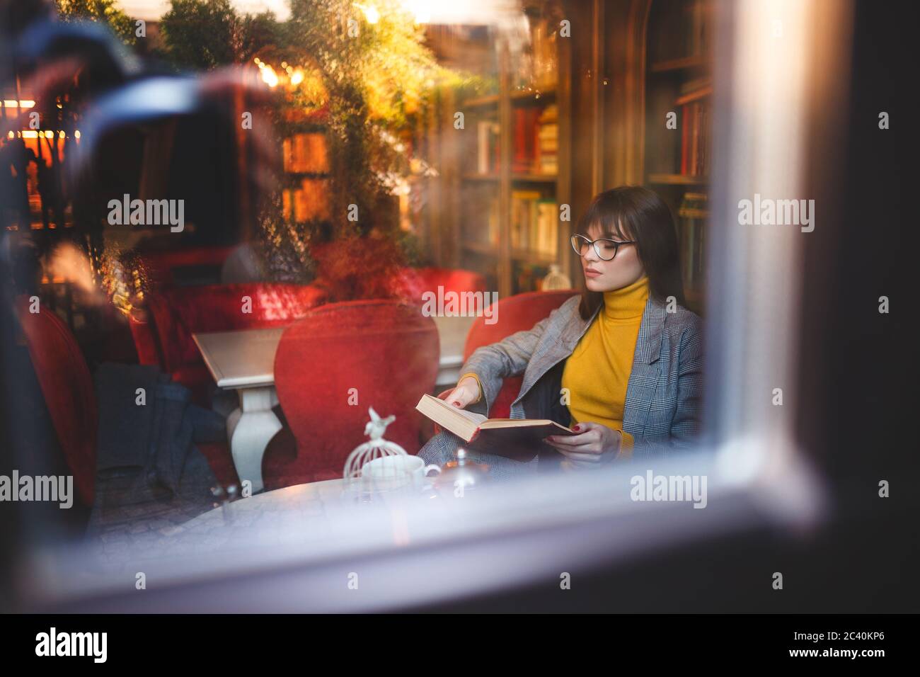 Beautiful dreamy girl in stylish sharp glasses. In the library Stock ...