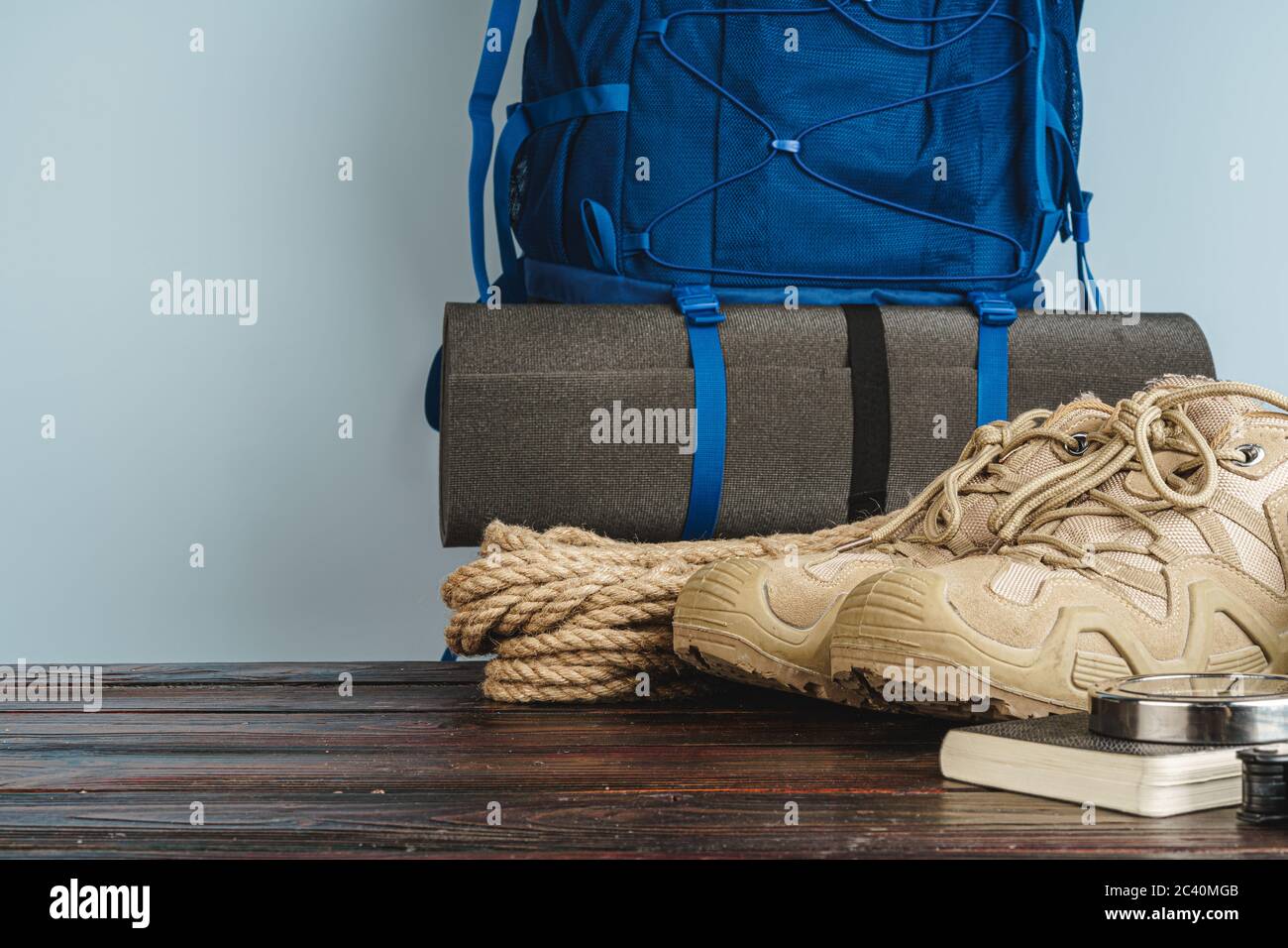 Hiking boots and rope hank on wooden board Stock Photo - Alamy