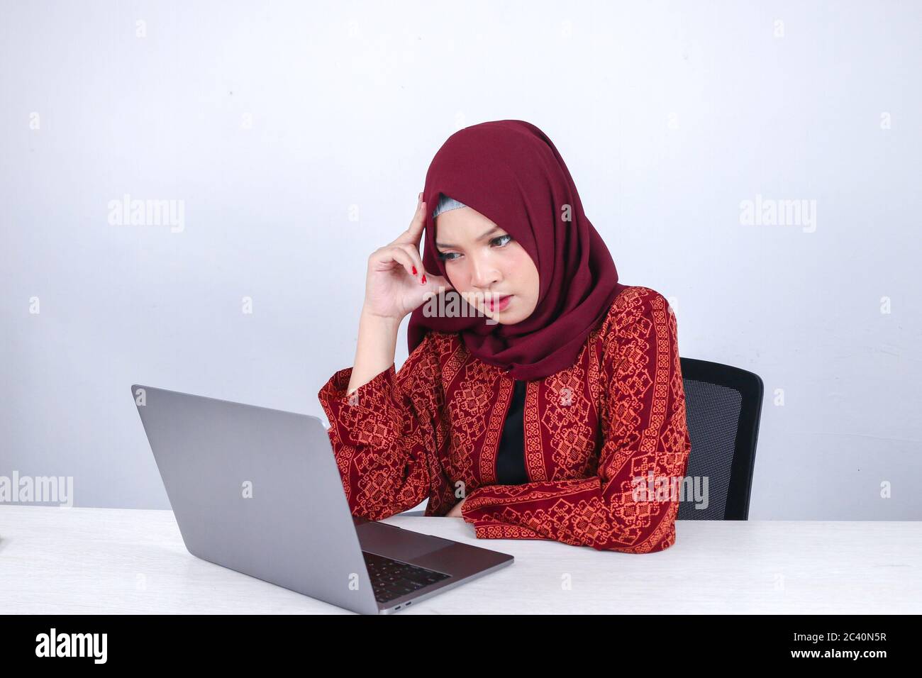 Young Asian Islam woman is serious look with thinking gesture hand on ...
