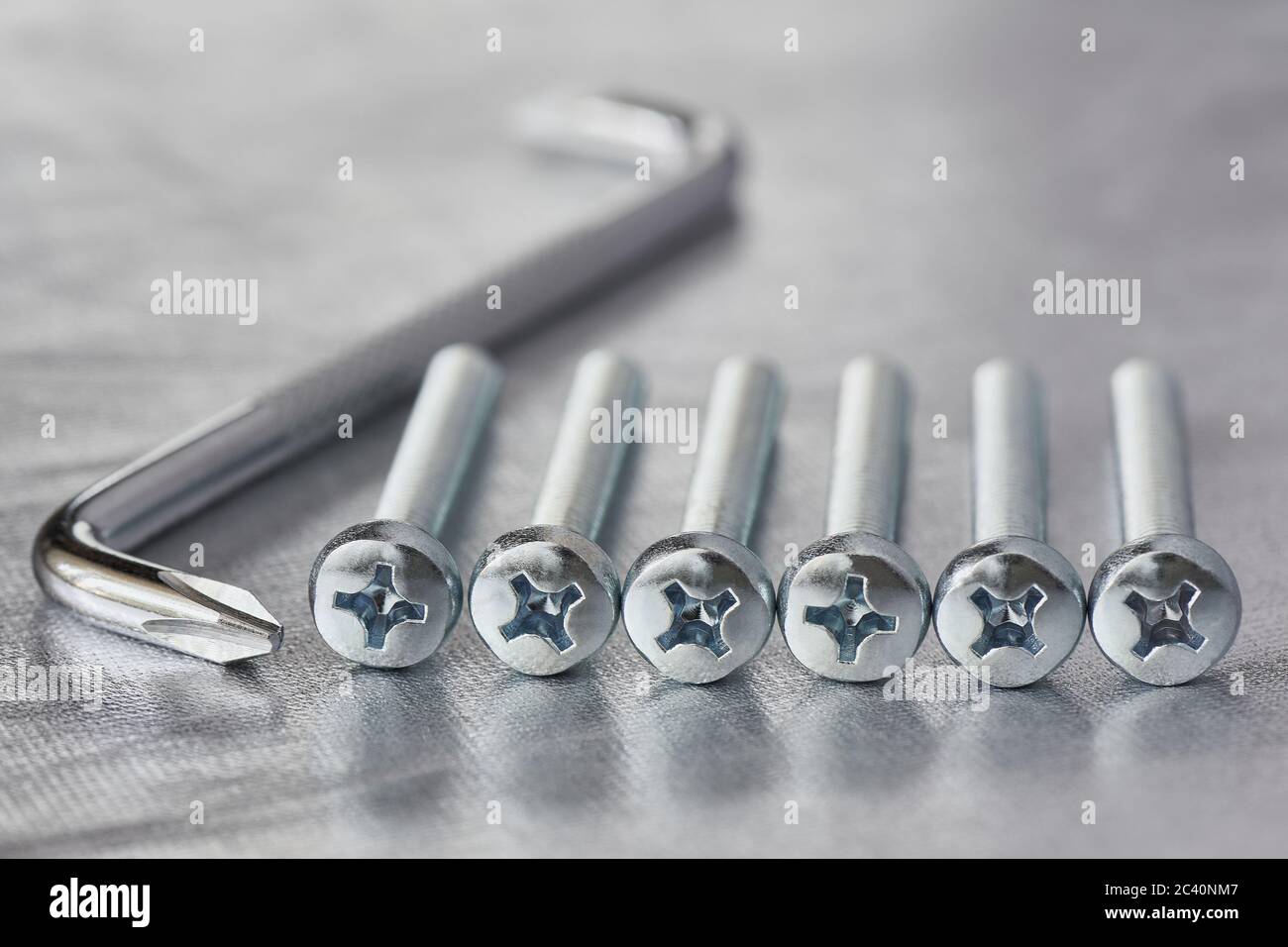 Group of screws and screwdriver on silver background, macro Stock Photo ...