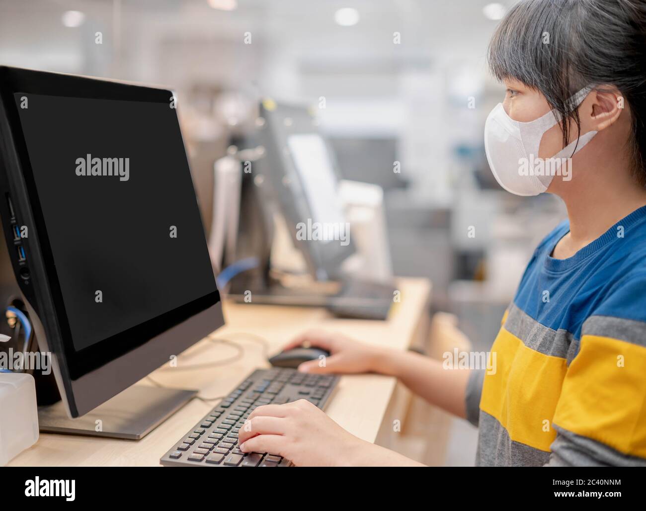 Female hand typing on the keyboard of Laptop and acrylic partition for ...