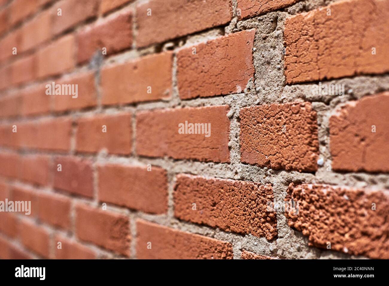 Loft red brick wall, angled view. Polished brick wall in attic interior ...