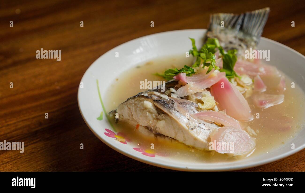 Steamed Rohu fish in Lemon Sauce with red onion and garnished with ...