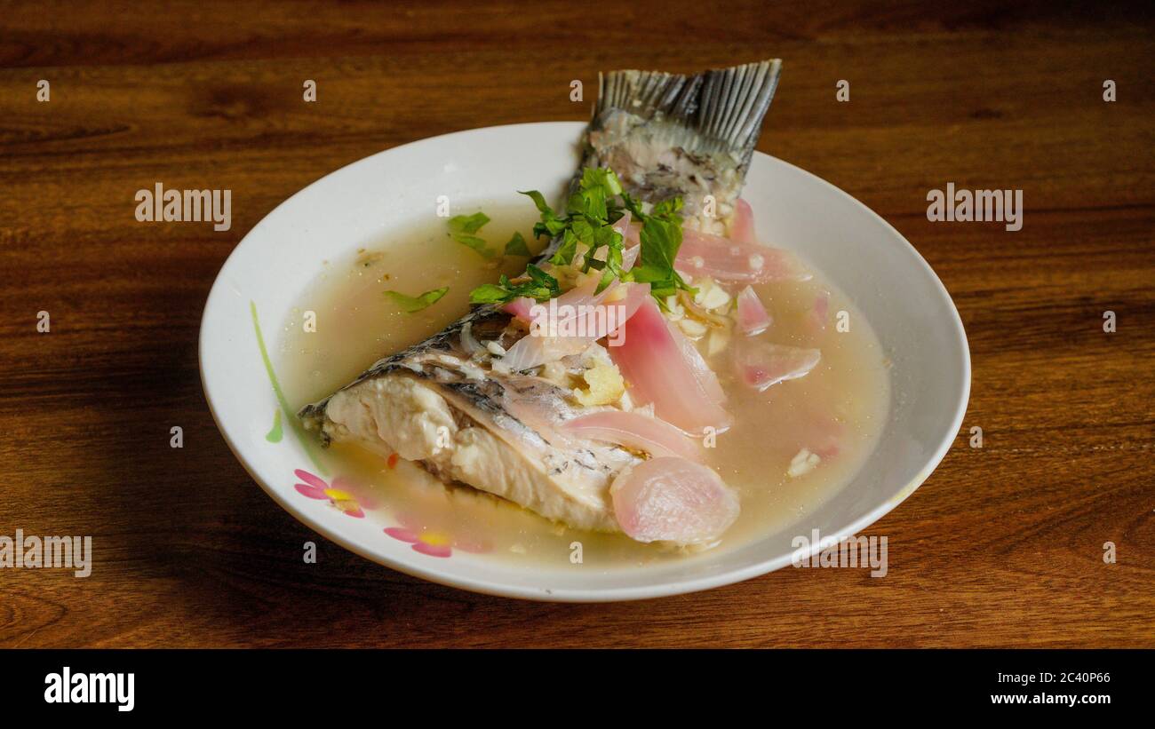 Steamed Rohu fish in Lemon Sauce with red onion and garnished with ...
