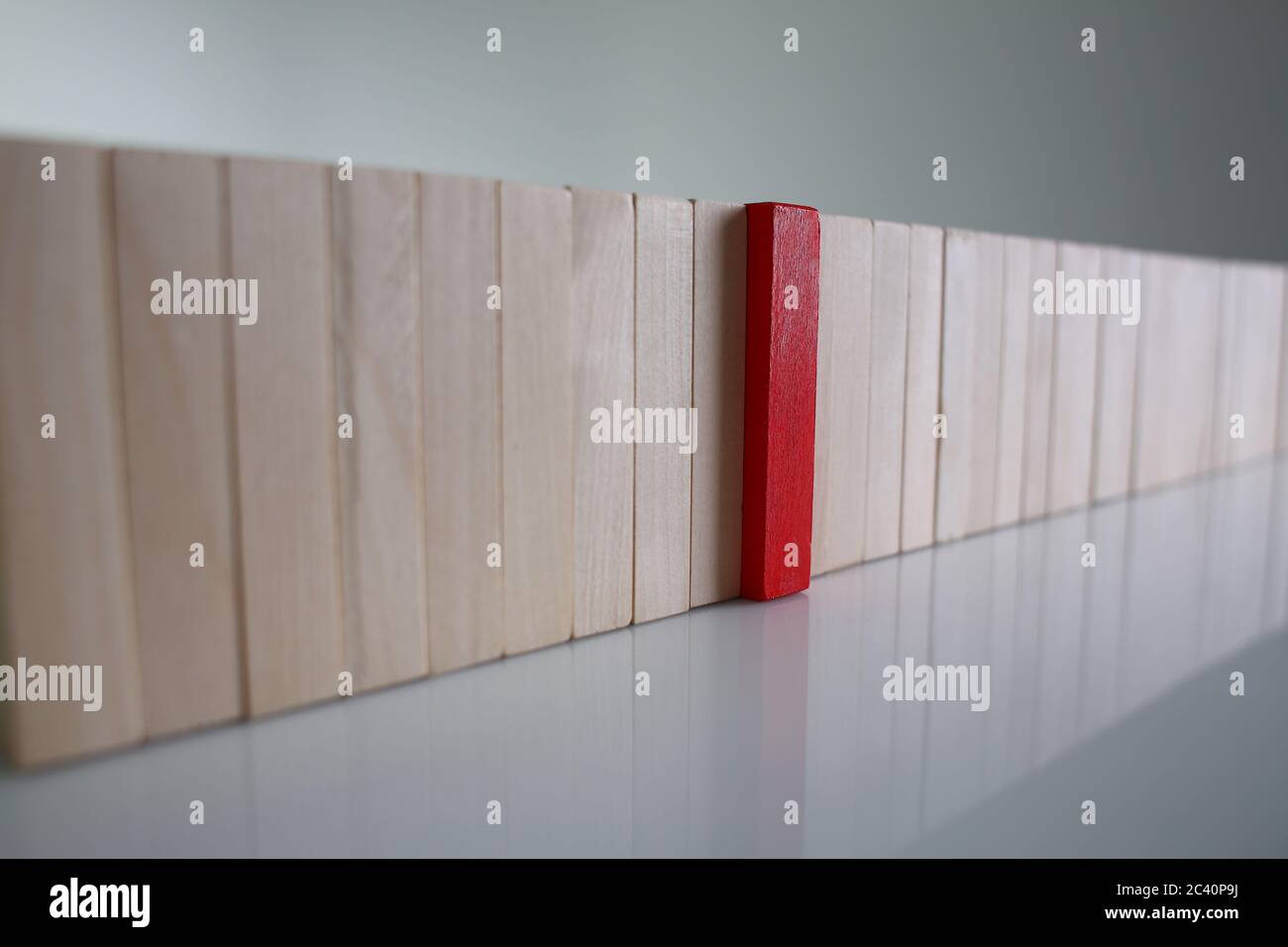 Wooden blocks with red leader forming straight line Stock Photo - Alamy