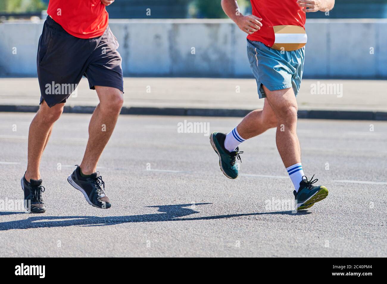 Running men. Sport men jogging in sportswear on city road. Healthy ...