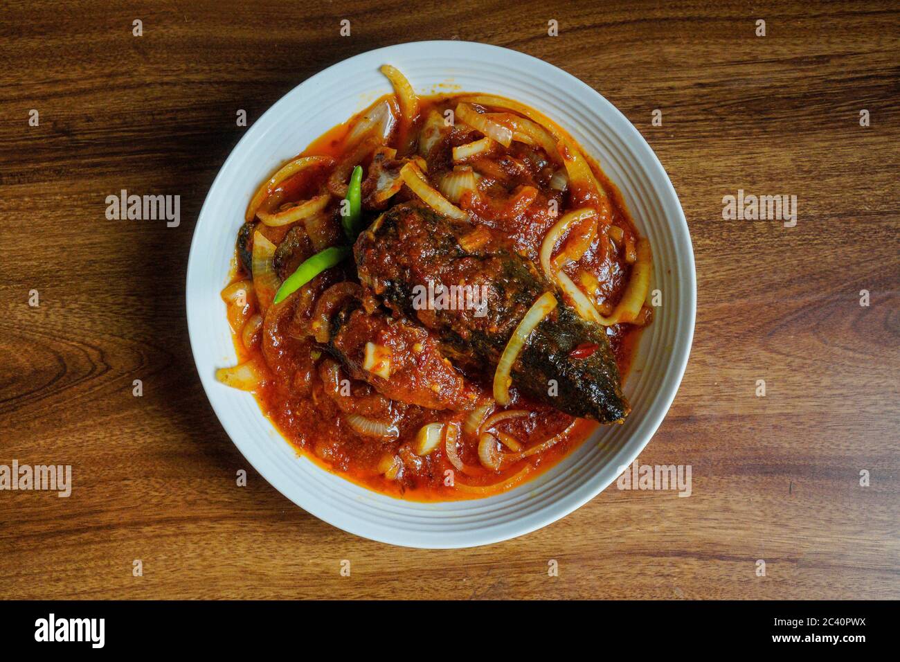 Fried silver catfish cooked with spicy sambal red chilli and onion with ...