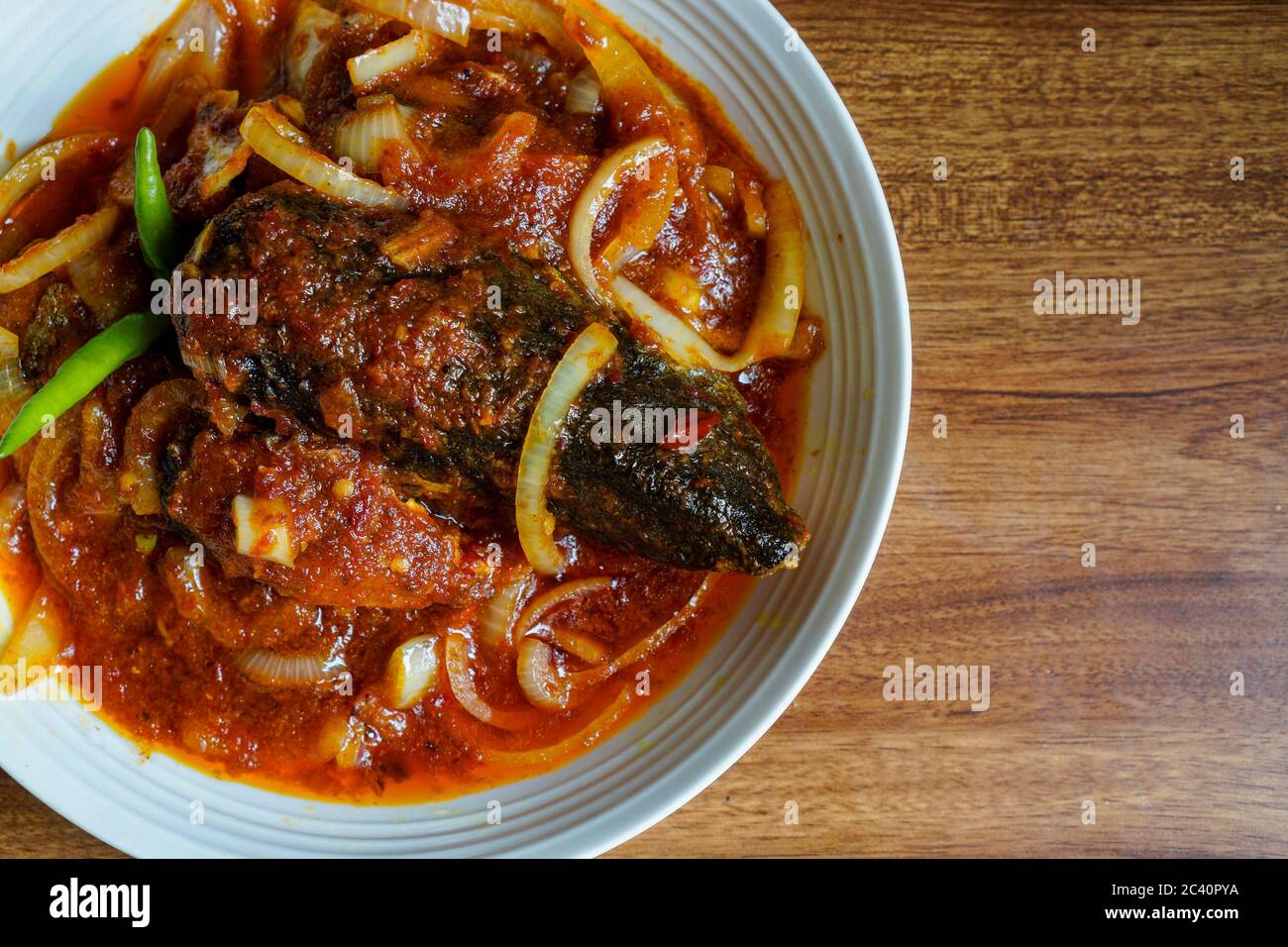 Fried silver catfish cooked with spicy sambal red chilli and onion with ...