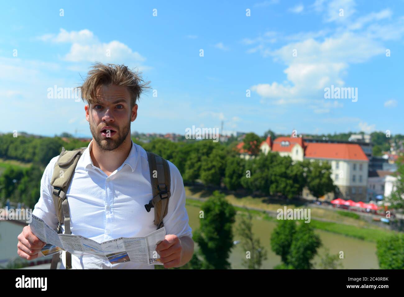 Tourists on the street holding a guide. Traveller on street trying to ...