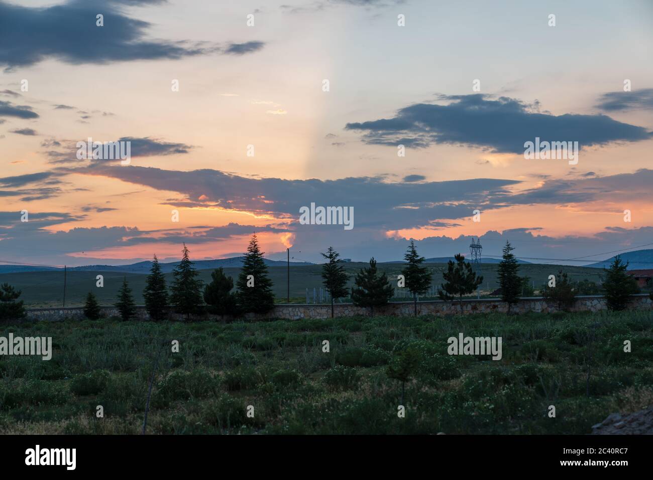 View of hill and orange colour clouds from Karaagac village, Emirdag ...